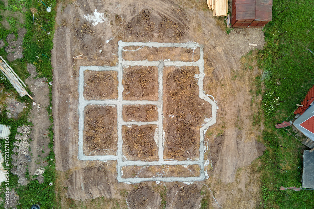 Top down aerial view of building works of new house concrete foundation ...