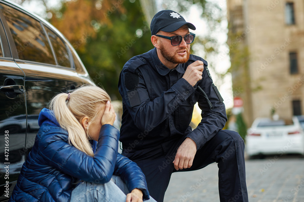 Male police officer helps a female driver Stock Photo | Adobe Stock
