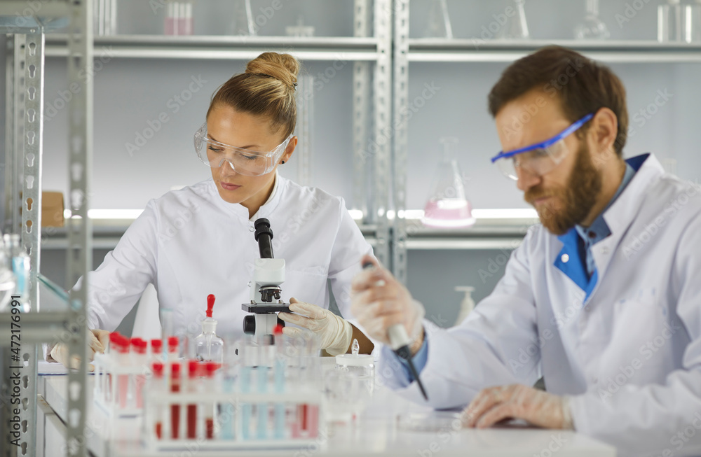 Work process in medical biotechnological chemical laboratory. Female ...