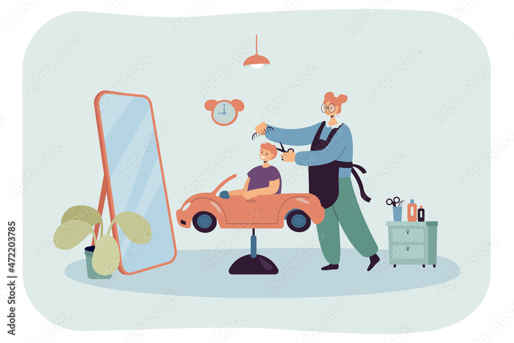 Child sitting on car chair in front of mirror in barber shop ...