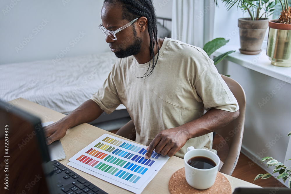 Designer man thinking about new project while working with color ...