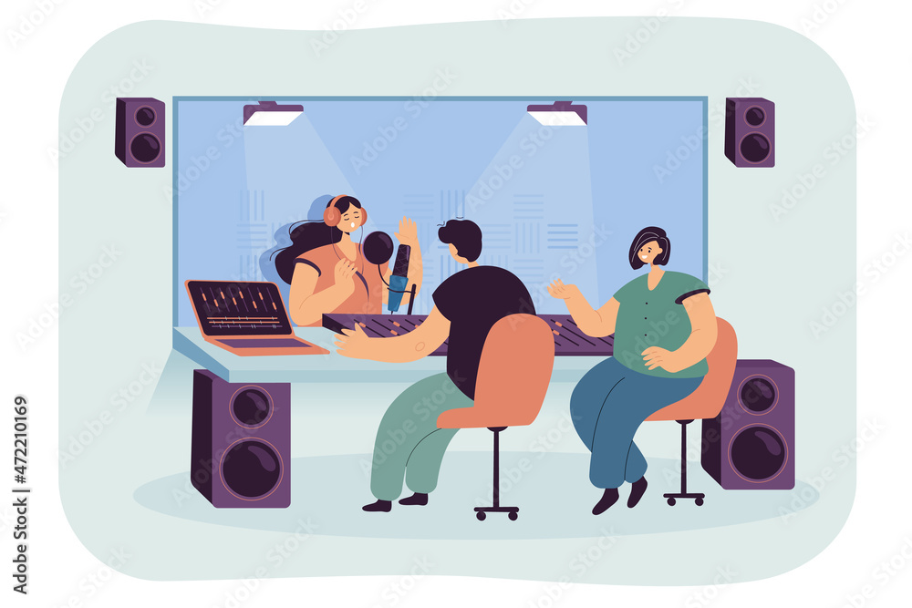 Sound engineer sitting on chair at desk with mixing console working in ...