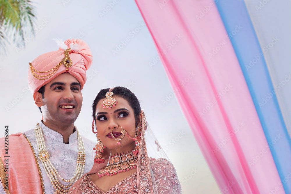 Indian bride and groom in traditional wedding dress Stock Photo | Adobe ...