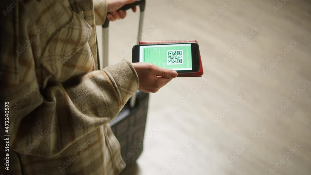 Tourist showing QR code on phone in airport terminal. Vaccination ...