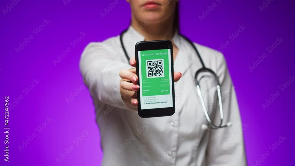 Woman doctor in medical uniform showing vaccination passport with qr ...