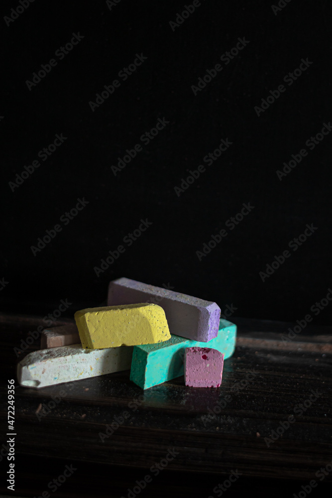 Colored crayons. Chalk for a slate board. Multi-colored chalk ...