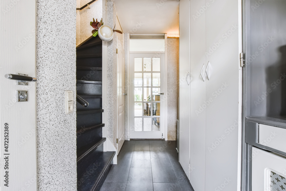 Small corridor with a back staircase and a door opposite Stock Photo ...
