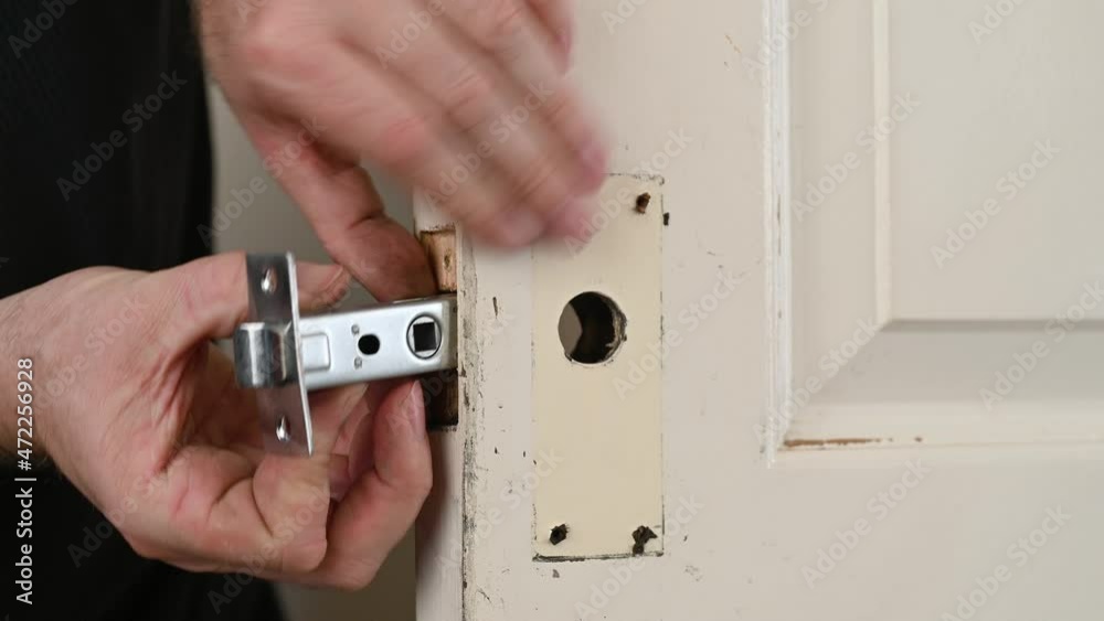 Hands insert door lock barrel into internal door Stock Video | Adobe Stock