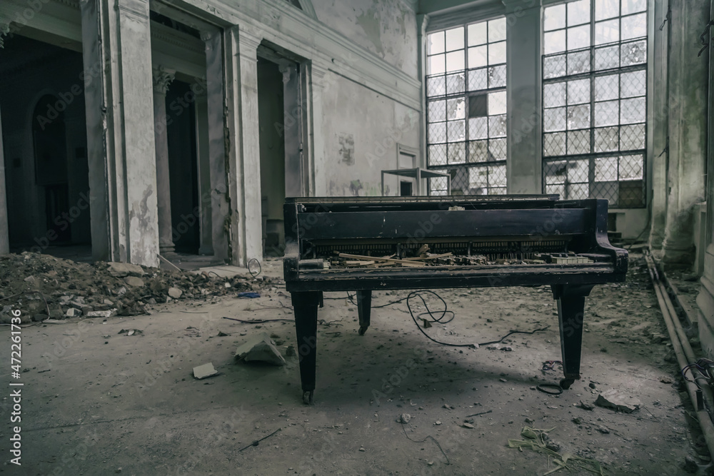 An old abandoned grand piano in an old abandoned building. An ancient ...