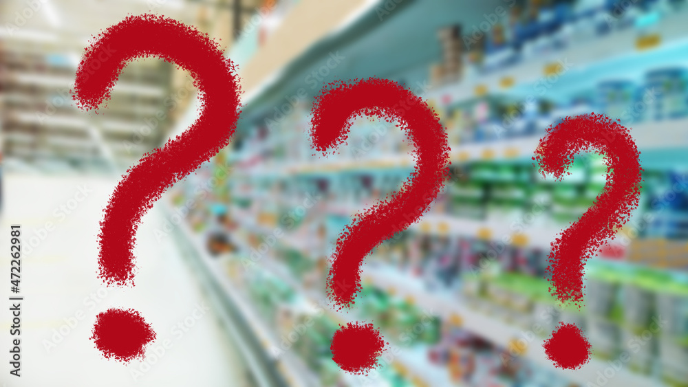 Three large red question mark on abstract blur image of supermarket ...