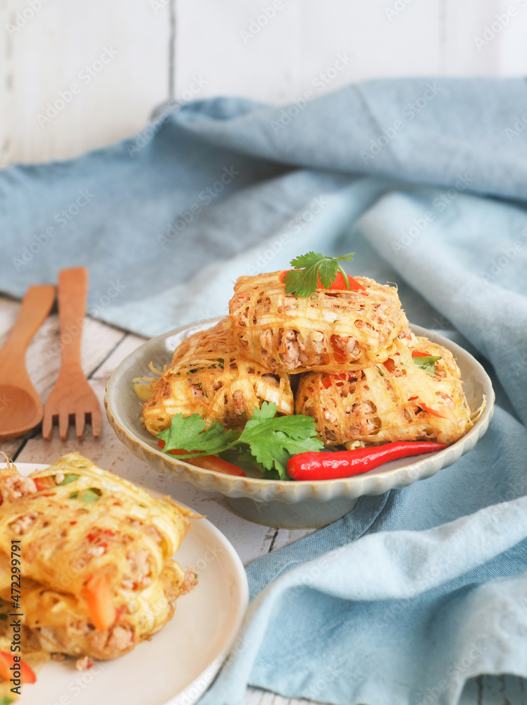 Thai traditional appetizer omelette net or "La Tiang" in Thai, wrapping ...