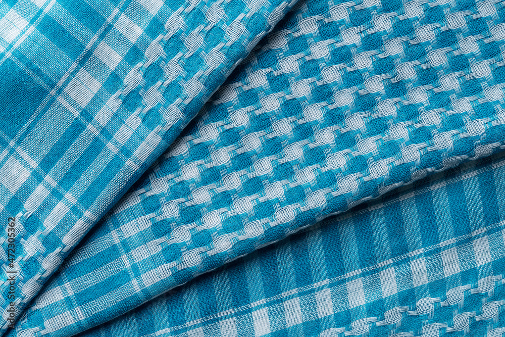 Folded keffiyeh of azure white colors background. Draped cotton shemagh ...