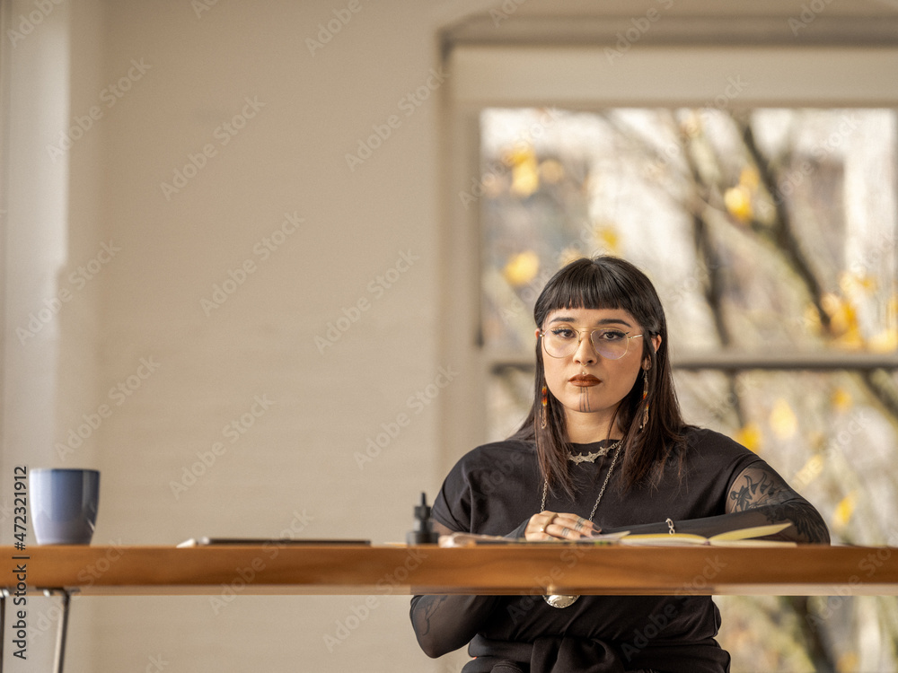 Non binary Indigenous artist drawing indoors Stock Photo | Adobe Stock