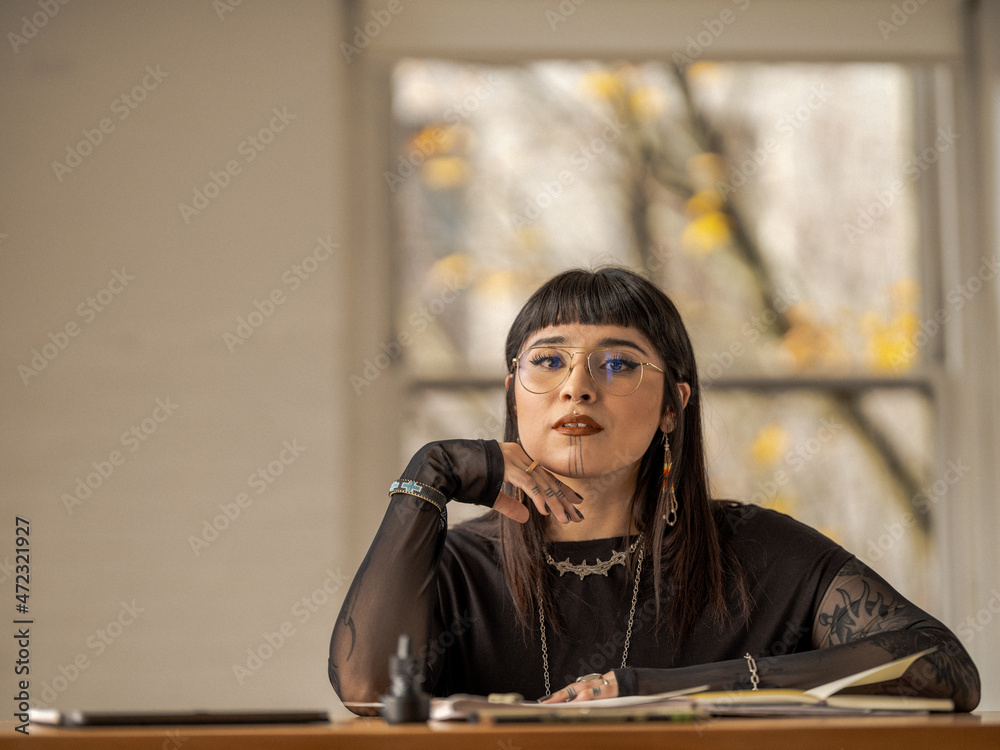 Non binary Indigenous artist drawing indoors Stock Photo | Adobe Stock