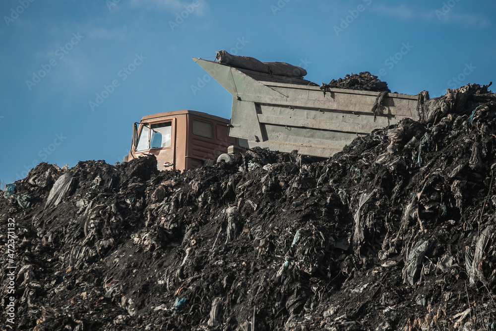 Recycling concrete and construction waste from demolition. Excavator at ...