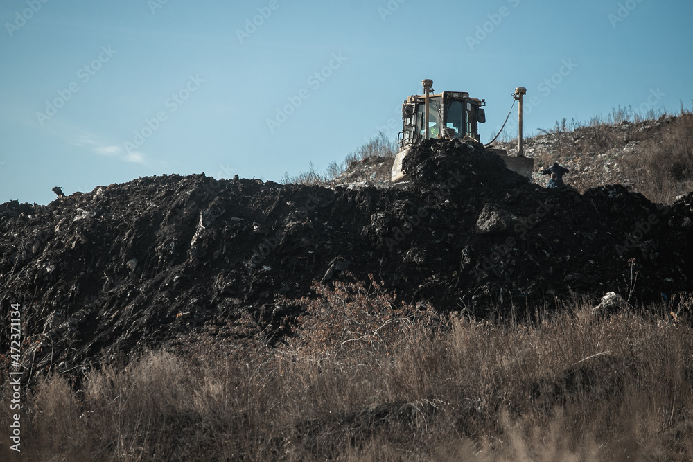 Recycling concrete and construction waste from demolition. Excavator at ...