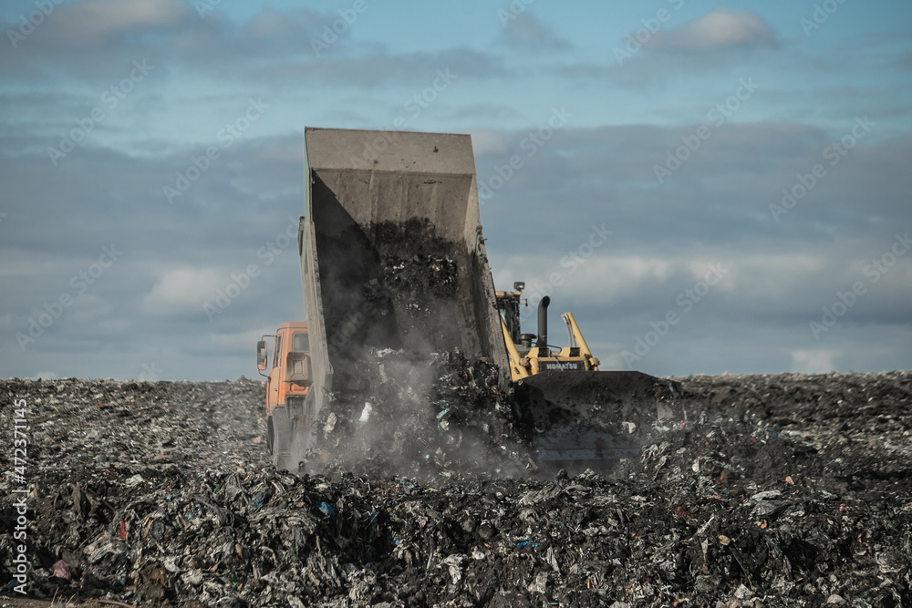 Recycling concrete and construction waste from demolition. Excavator at ...