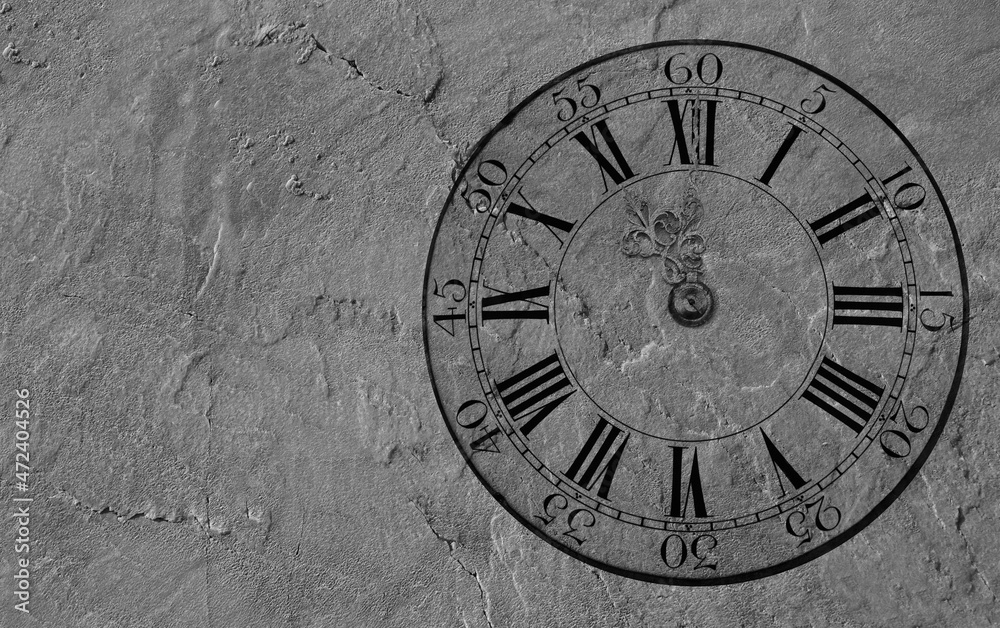 black clock on stone wall background with empty copy space for ...