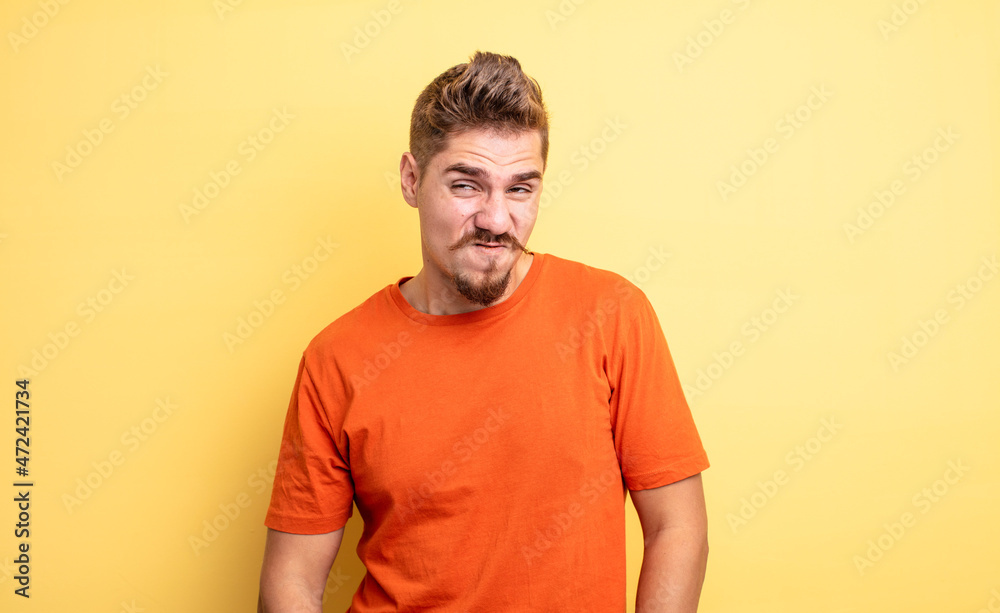 young handsome man looking goofy and funny with a silly cross-eyed ...