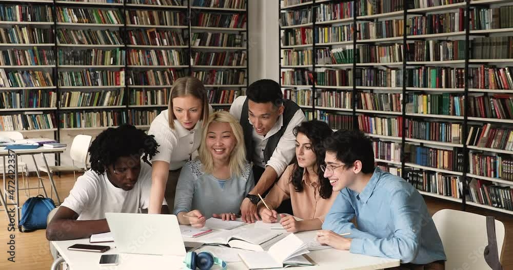 Multiracial students use laptop study together, prepare for exams ...