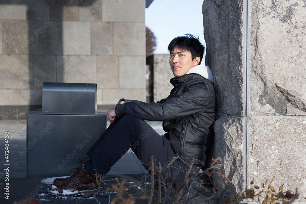 Full-length view of young asian man with haughty expression seen ...