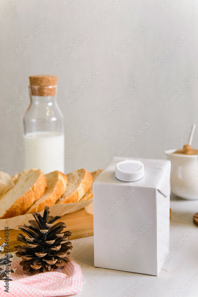 blank half liter milk box packaging with lid on a table with breakfast ...