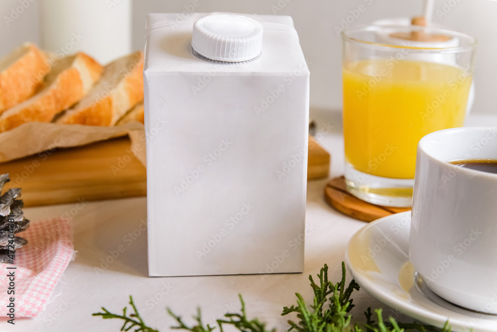 blank half liter milk box packaging with lid on a table with breakfast ...
