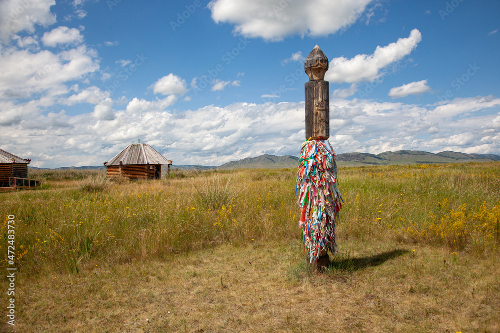 Totem pole tied with ritual ribbons. Salbyk mound in the steppe of ...