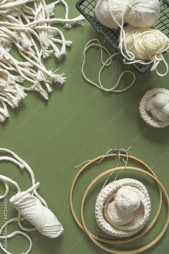 Macrame. Handmade macrame weaving and cotton threads on a rustic wooden ...