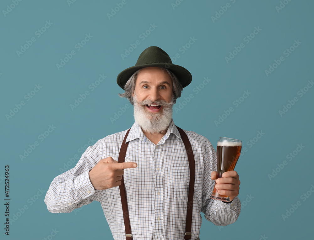 Handsome senior man in traditional German clothes and with beer on ...
