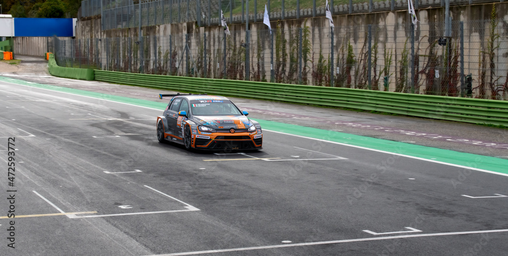 Volkswagen Golf GTI racing touring car action speed on straight asphalt ...