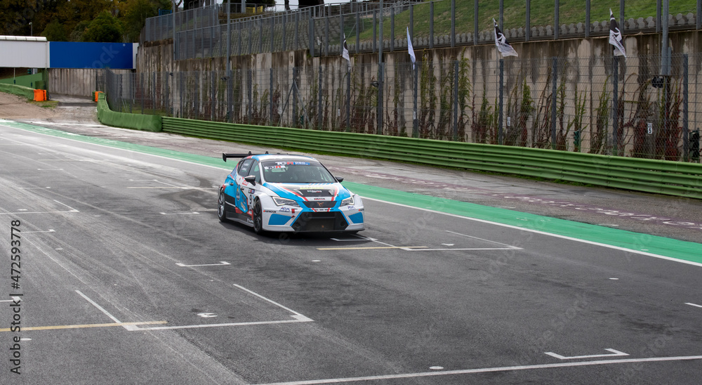 Cupra TCR racing touring car action speed on straight asphalt racetrack ...