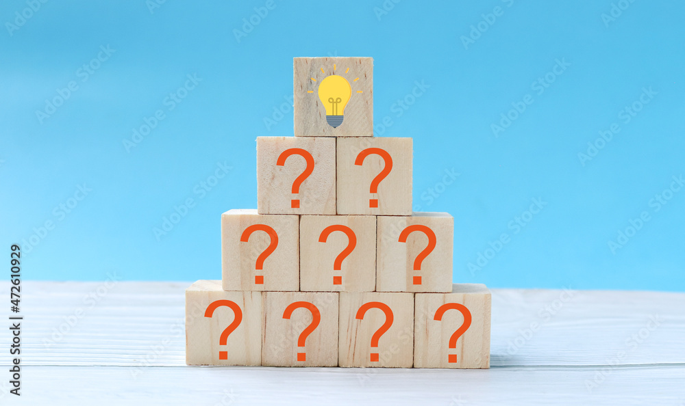 Question mark and light bulb on wooden blocks lined up. Ideas, question ...