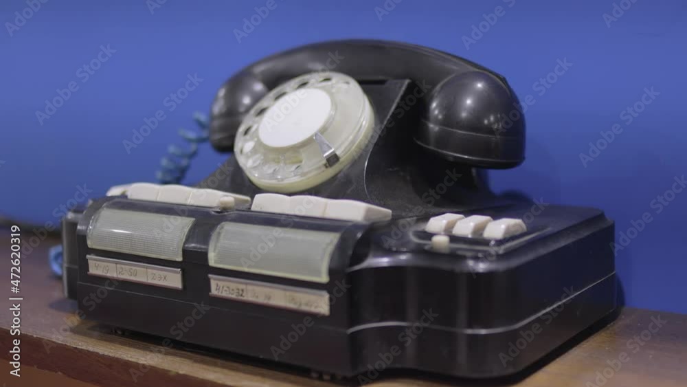 An old vintage telephone with a dial, buttons for switching and a ...