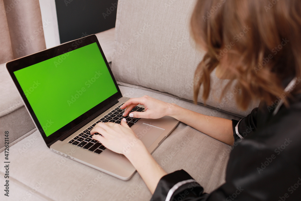 young woman using computer with Mock-up chrome key green computer ...