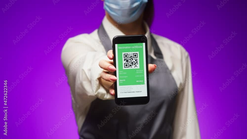 Woman worker showing on phone vaccination passport with qr code on ...