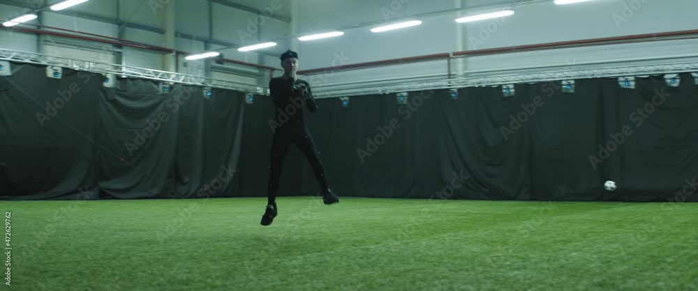 Soccer football player wearing motion capture suit performing kicks and ...