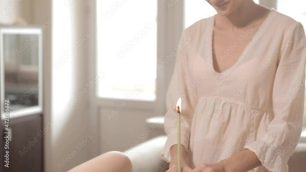 Beautiful Woman Receiving Ear Candle Treatment Therapist Performing An