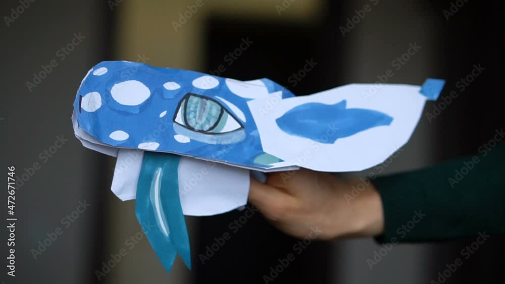 Blue origami dragon with long tongue in child hands, paper dragons ...