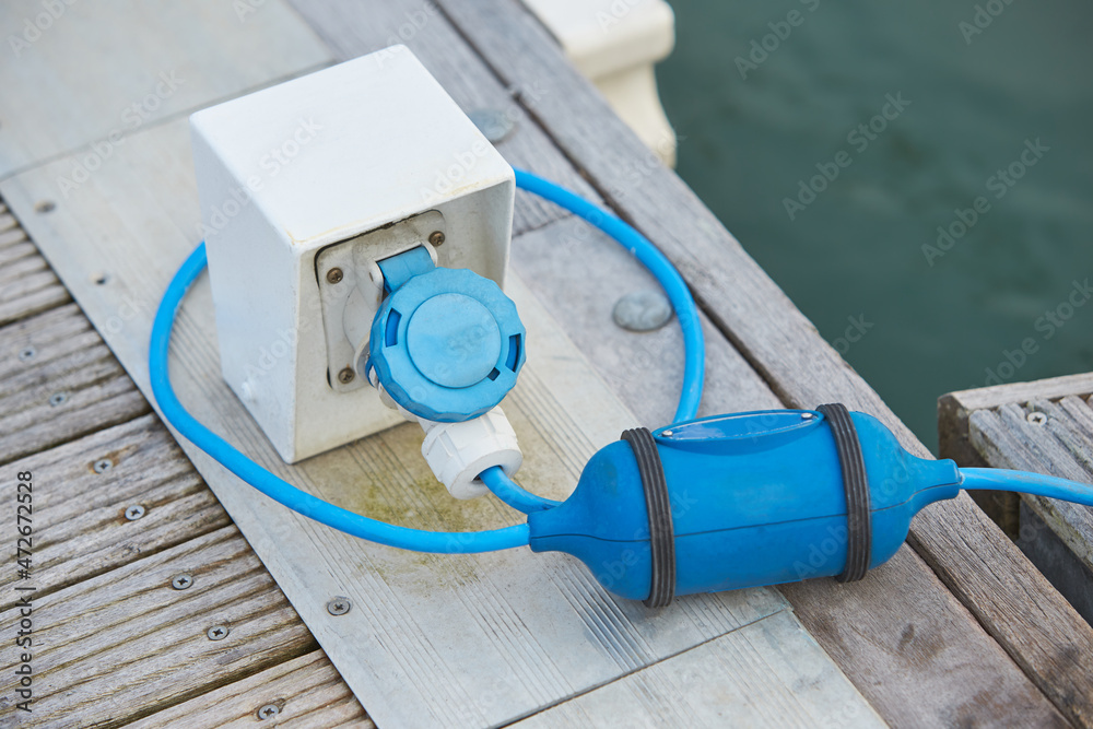 Electrical power socket bollard on pier. Charging station for boats in ...