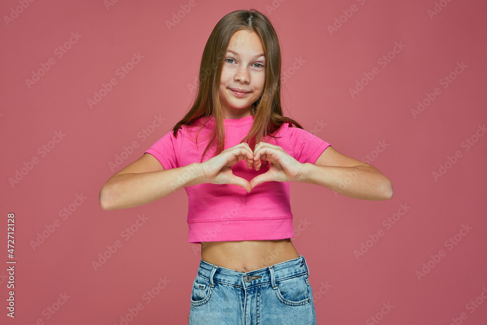 Adorable little girl child showing love sign, making heart gesture on ...