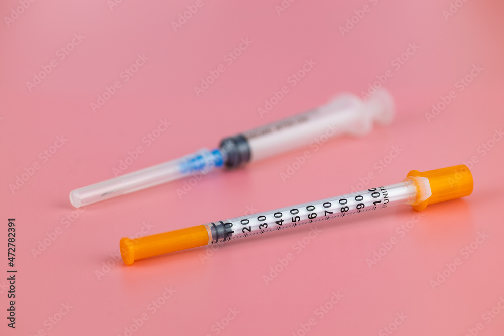 Insulin syringe and medical syringe pink background. Health and ...