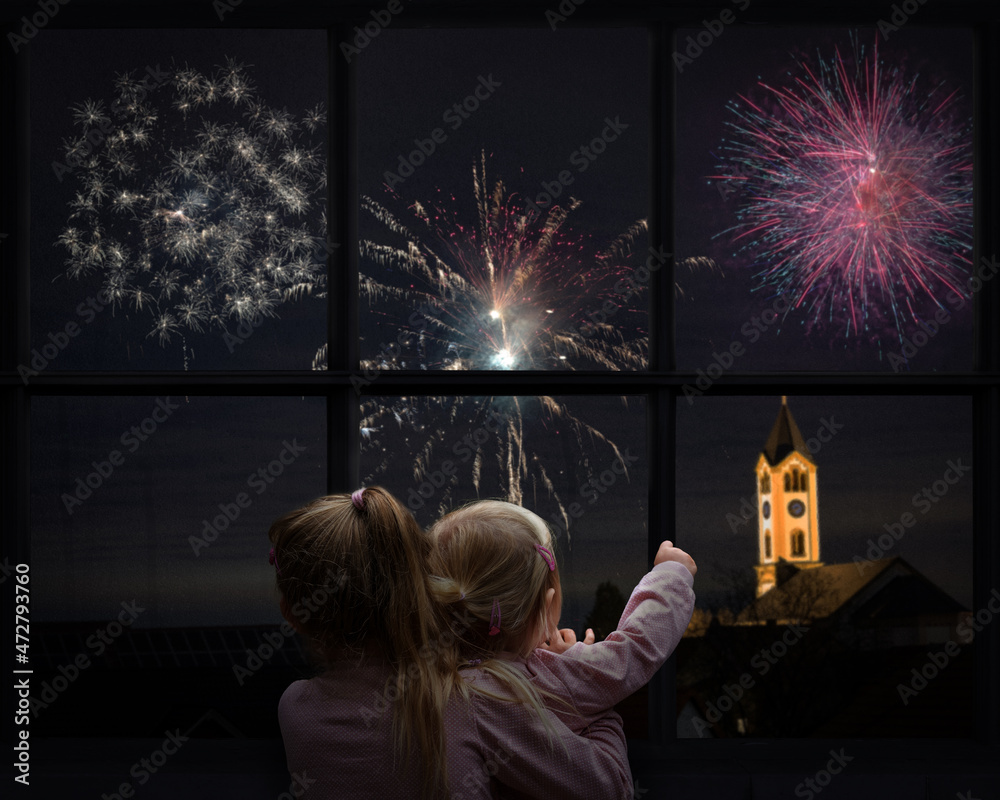 View through window of two Kids watching fireworks Stock-Foto | Adobe Stock