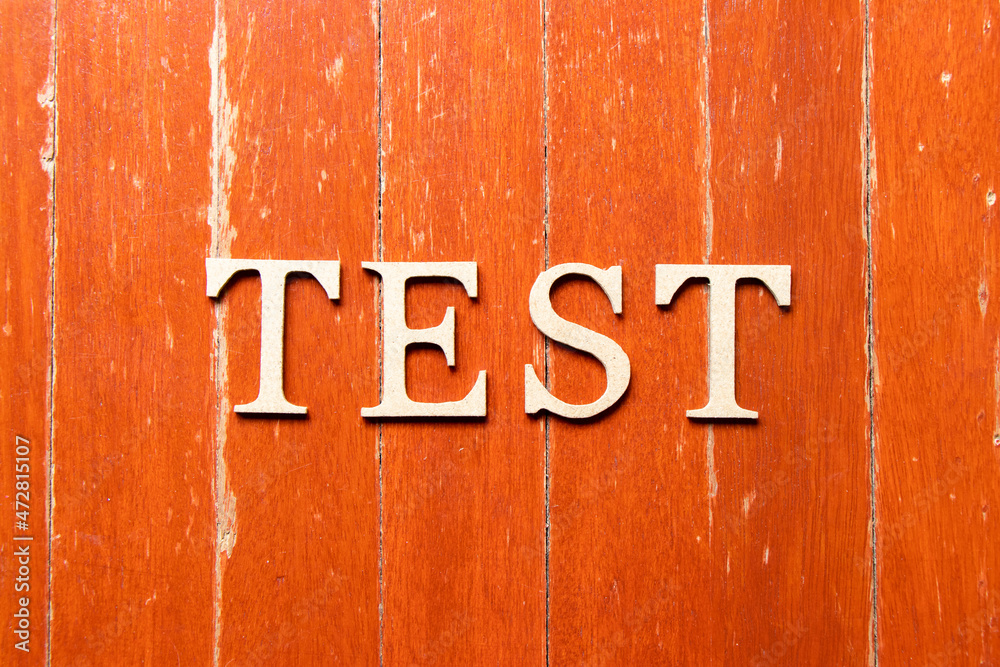 Alphabet letter in word test on old red color wood plate background ...