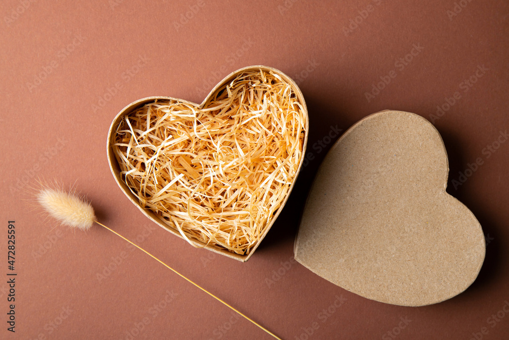 Top view of natural color open heart shape cardboard box with shredded ...