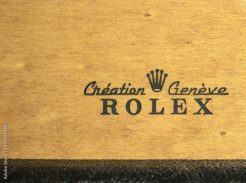 Rolex logo on wooden background.Crown is a symbol of luxury and ...