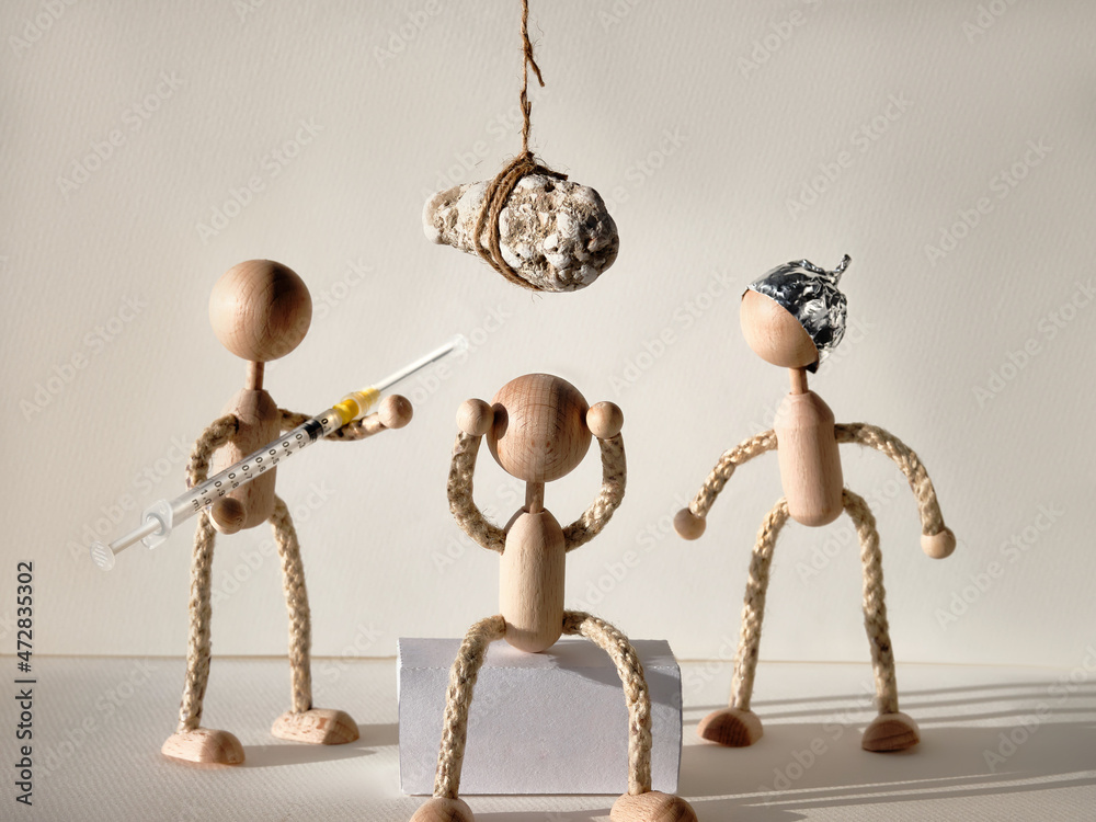 Dilemma of mandatory vaccination. Confused wooden toy man in fear of ...