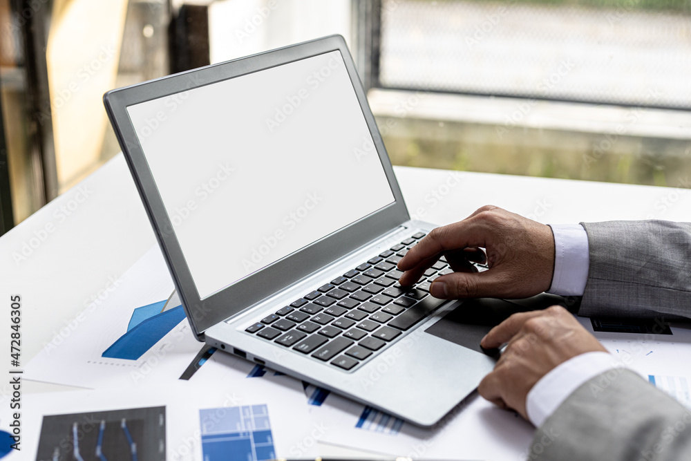 Person typing on laptop keyboard, on laptop screen blank white ...