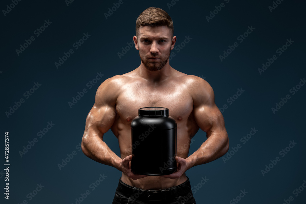 Waist up portrait view of sporty shirtless man stretching to the camera ...