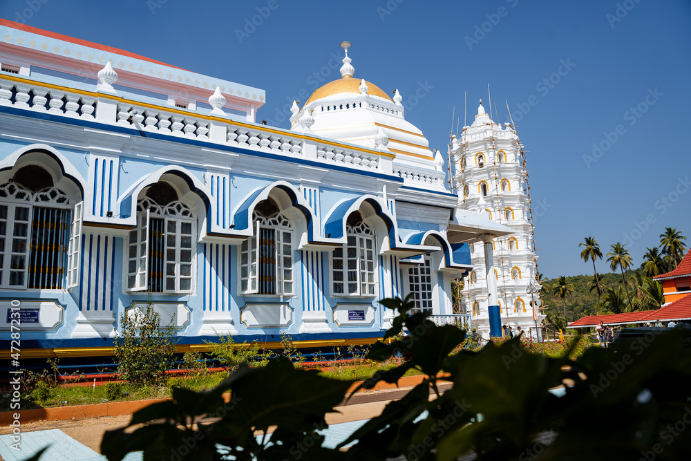 An Indian temple of blue color in clear weather. Goa pilgrim's journey ...